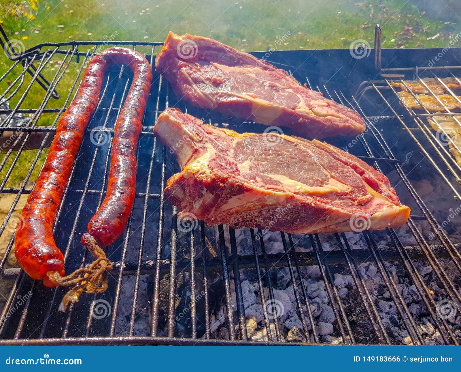 Beef and Cow Steak Grilled Next To Chorizo for Grilling Stock Photo ...