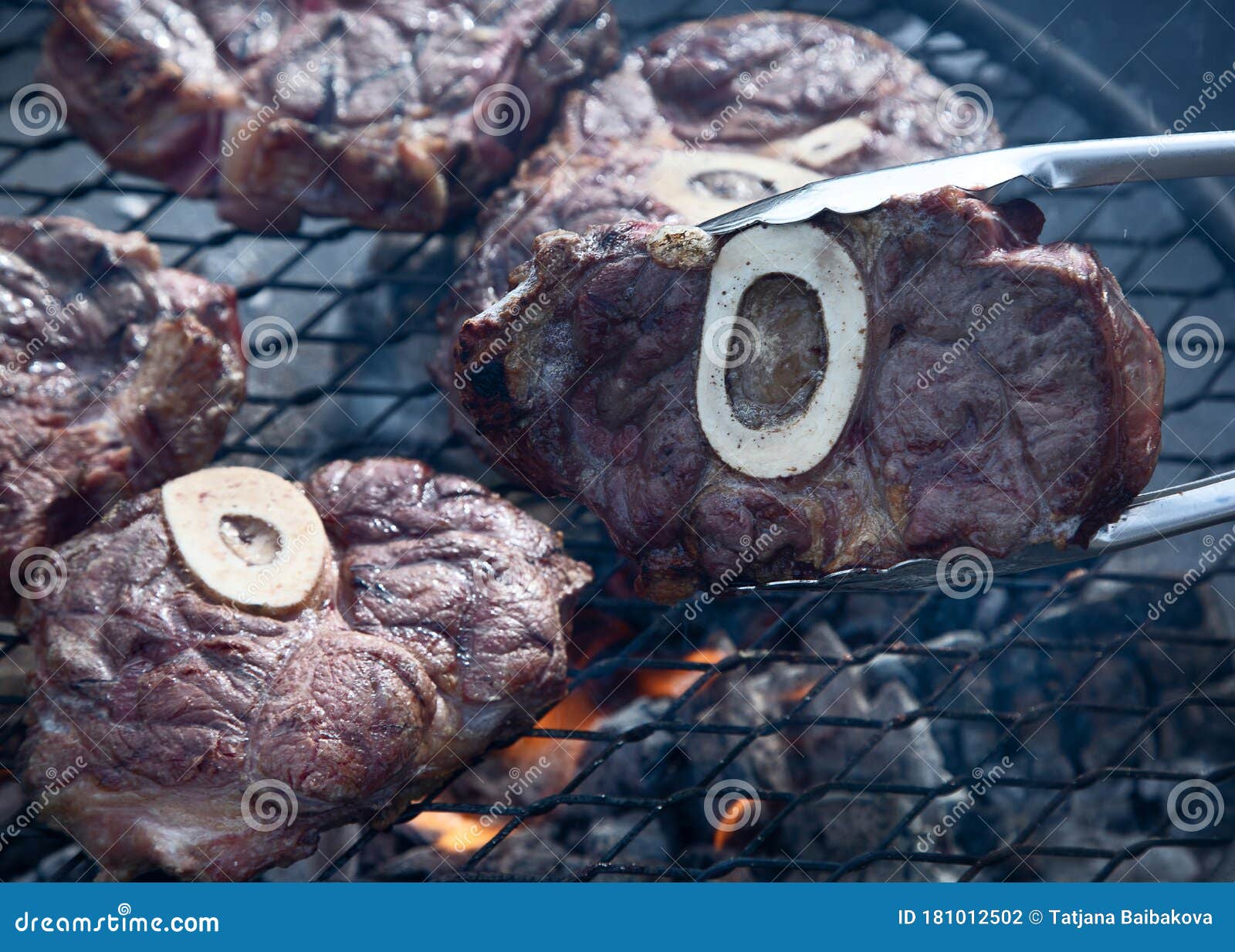 Beef Shanks on a Barbecue Grill Over Coals Stock Photo - Image of food ...