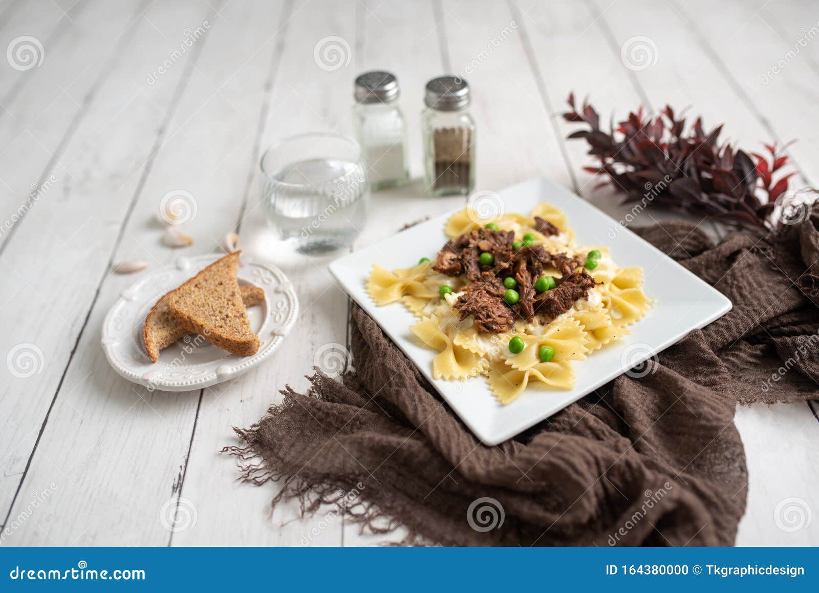 Beef Tips Over Bow Tie Pasta and Alfredo Sauce Stock Photo - Image of ...