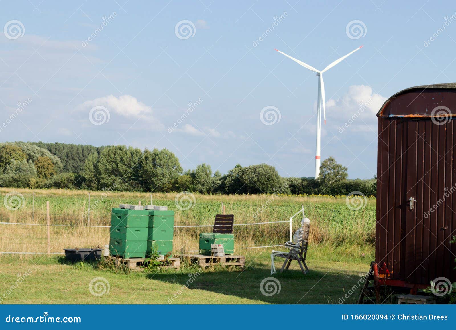 Beehive on Farmland and a Wind Mill in the Back Stock Photo - Image of ...