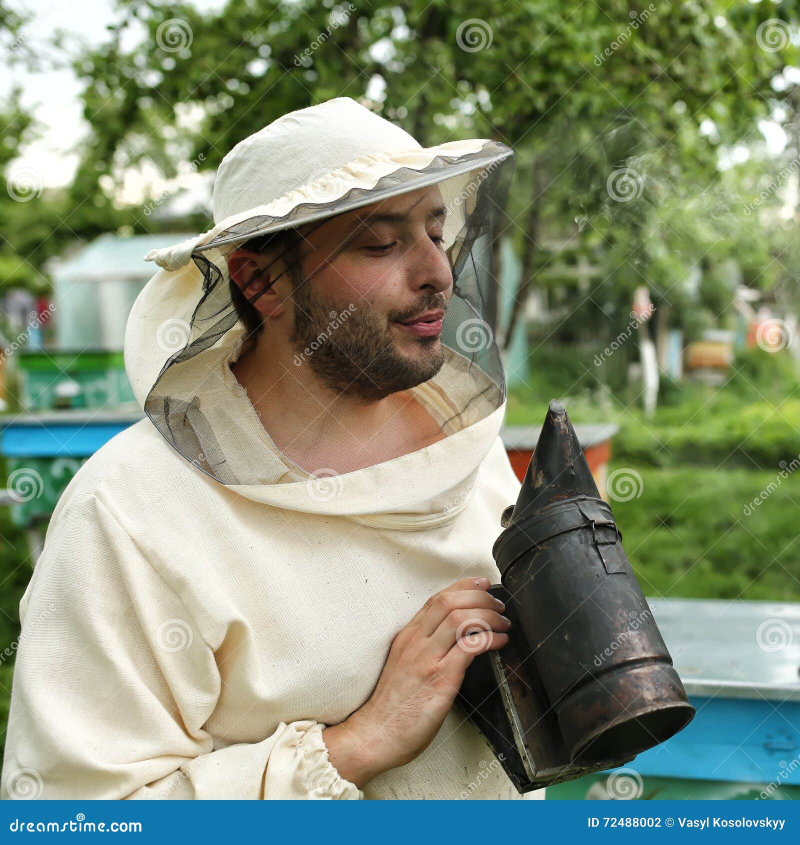 Beekeeper in Protective Clothing Holding Smoker Stock Photo - Image of ...