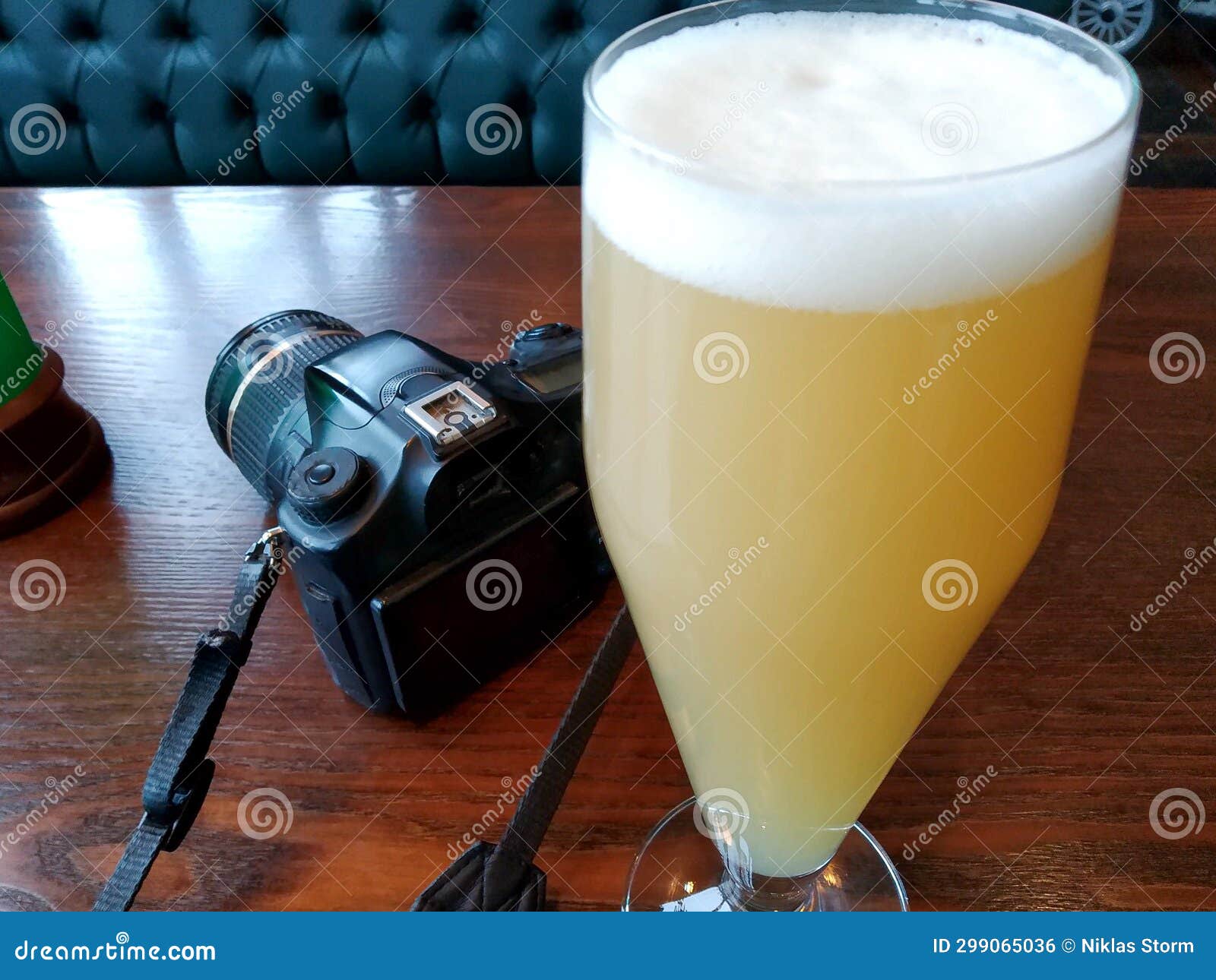 A Beer and a Camera on a Table Stock Photo - Image of indoors, alcohol ...