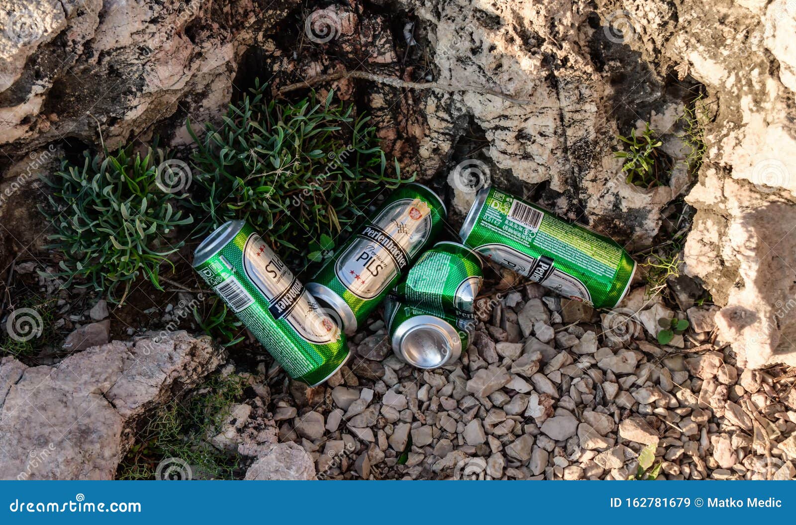 Beer Cans by the Rocks on the Beach Editorial Stock Image - Image of ...