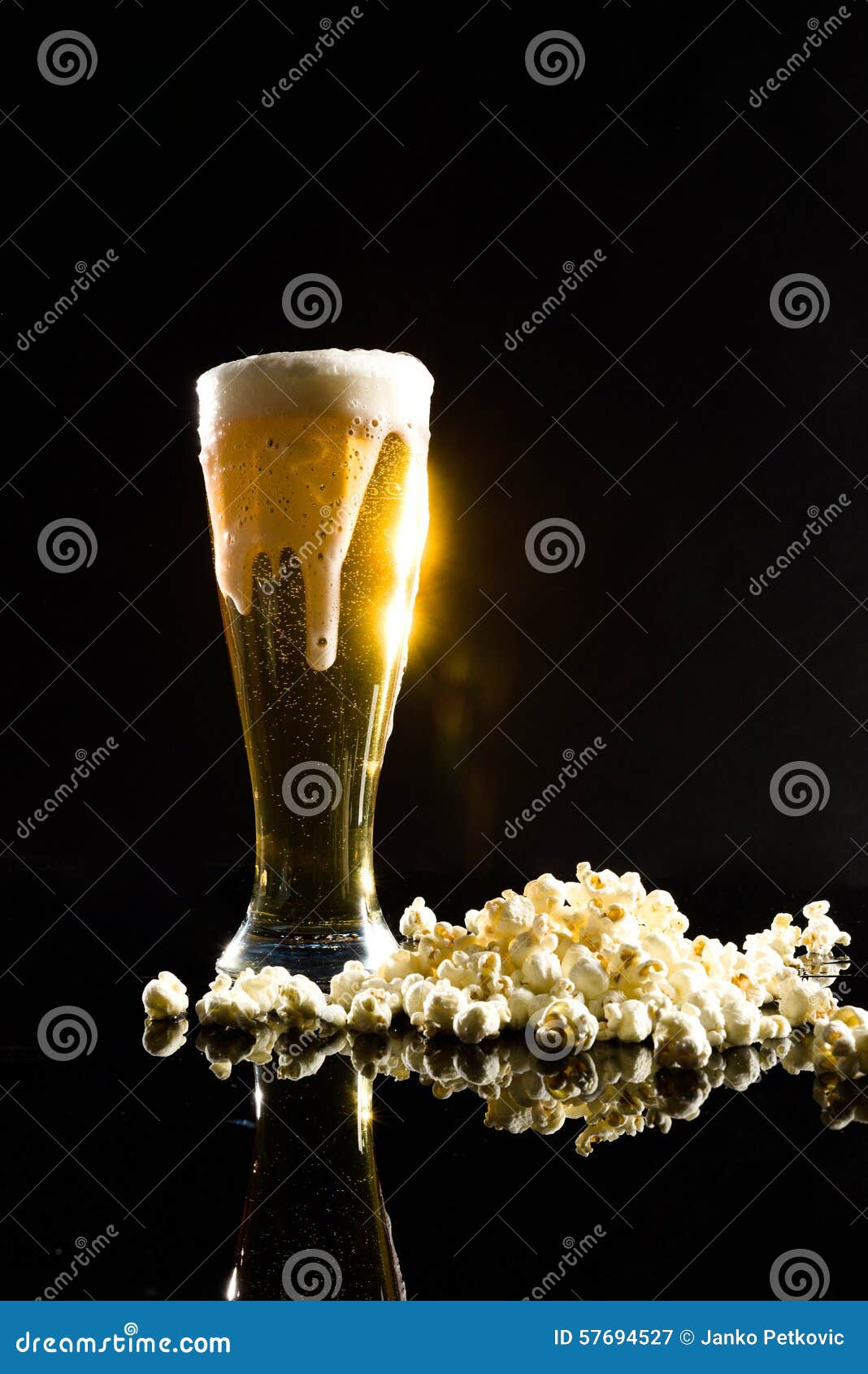 Beer with foam and popcorn stock image. Image of glass - 57694527