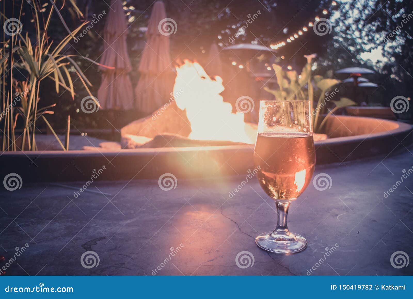 Beer Glass Illuminated by Fire Pit in Background Stock Photo - Image of ...