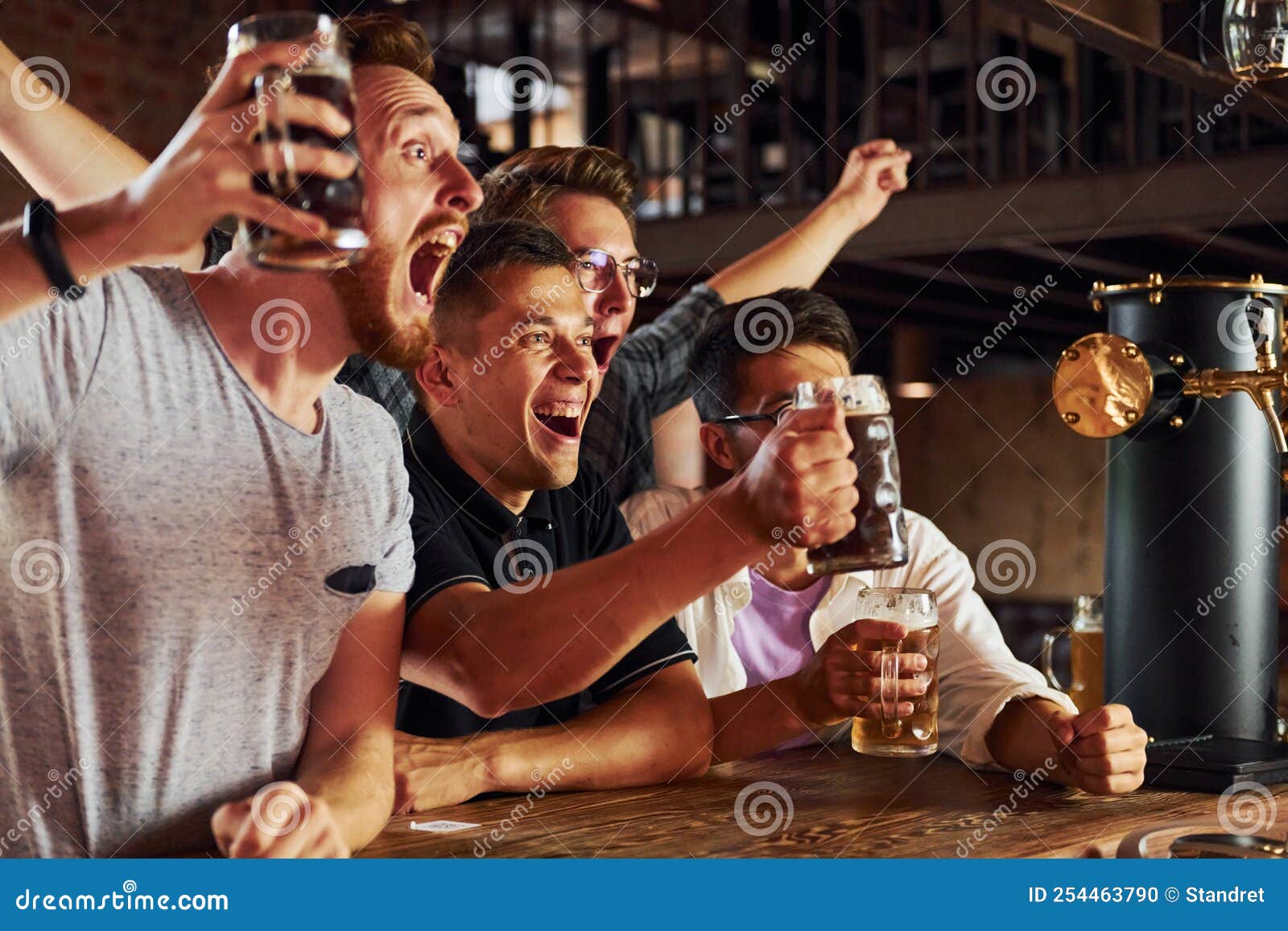 With Beer in Hands. People in Casual Clothes Sitting in the Pub Stock ...