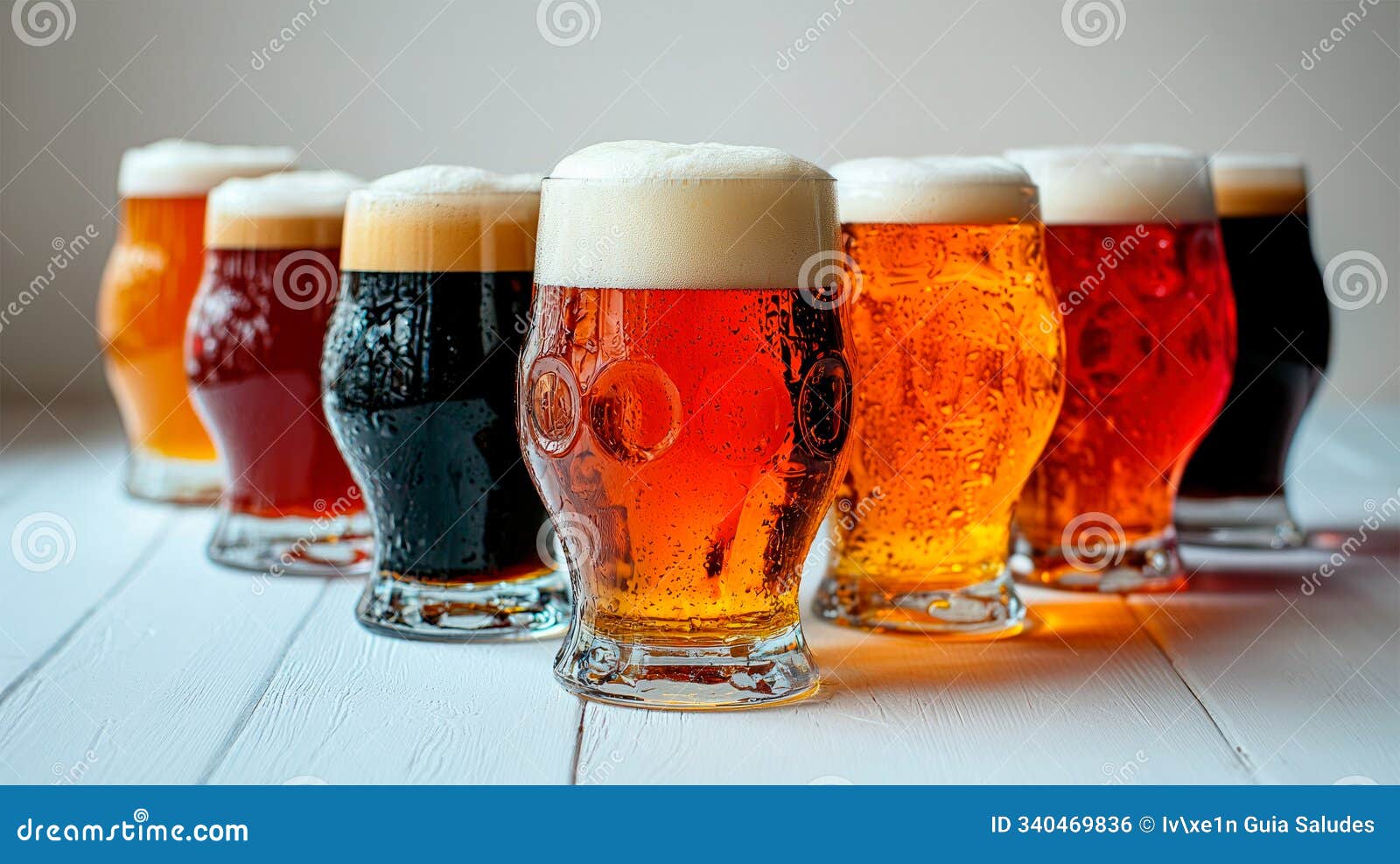 Beer Mugs of Different Types of Beers with Foam on a White Wooden Table ...