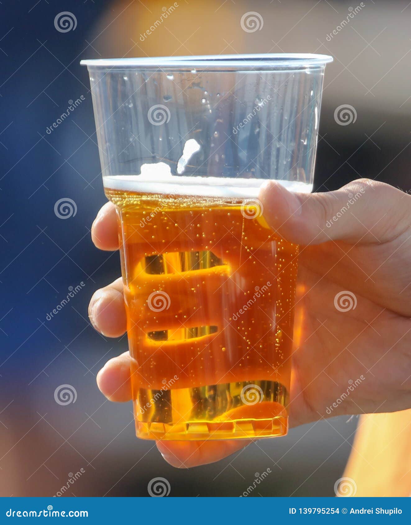 Beer in a Plastic Cup in Hand Stock Photo - Image of hand, glass: 139795254