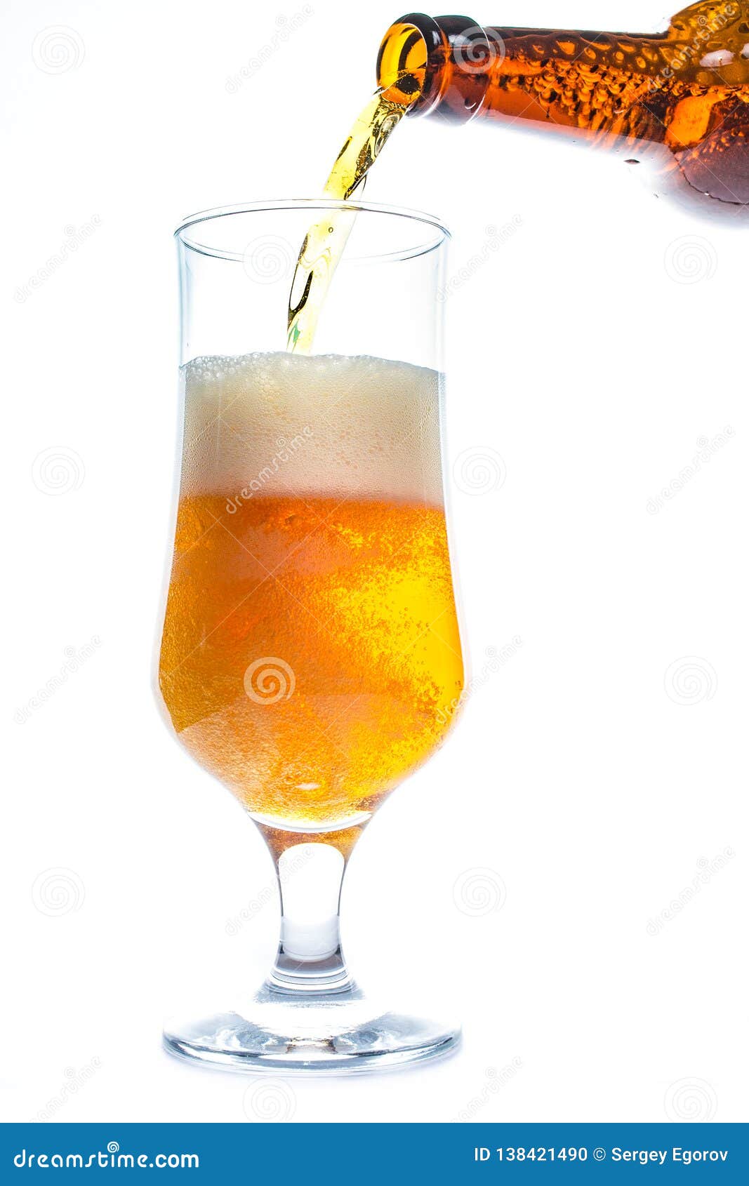 Beer Is Pouring Into A Glass From Bottle On White Background Stock