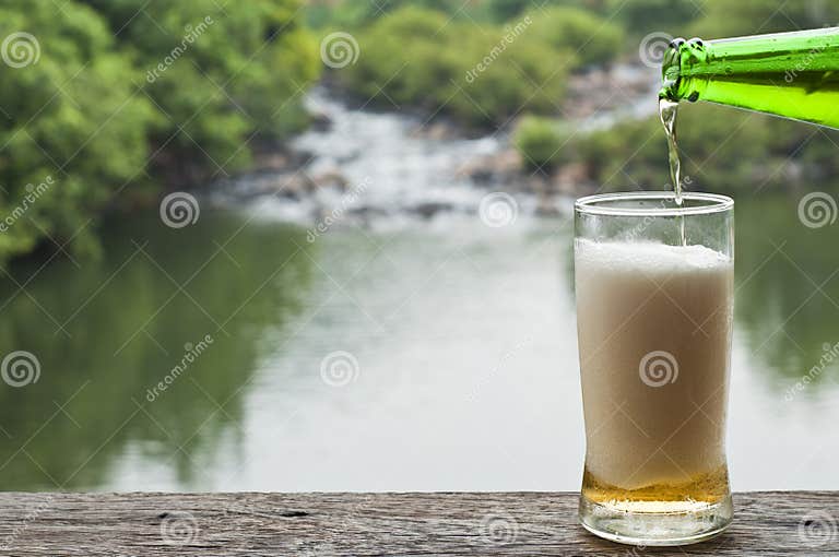 Beer at waterfall. stock photo. Image of green, pouring - 38320250