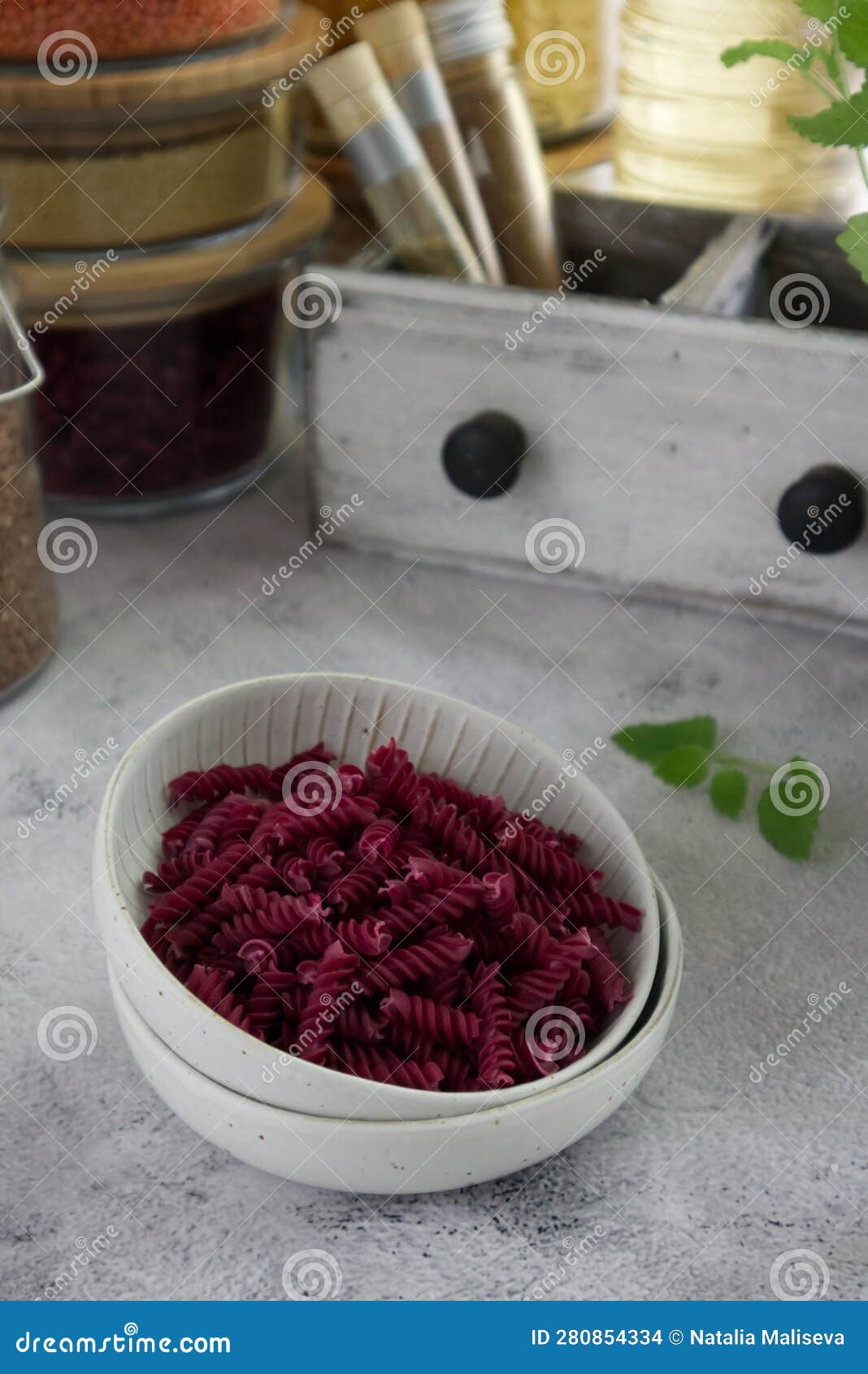 Beetroot Pasta in a Bowl on Table Against Rustic Decor Background Stock ...