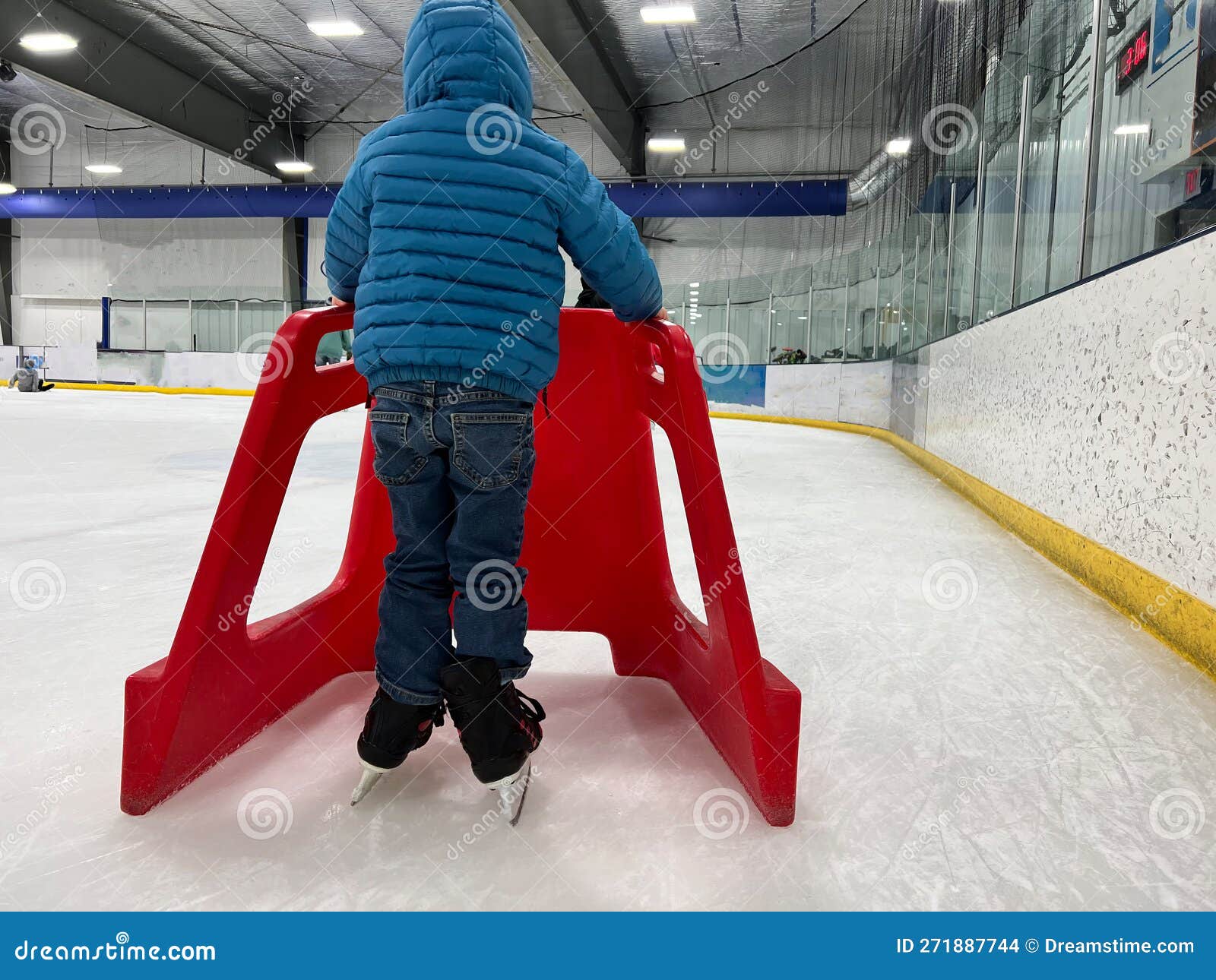 Beginner Ice Skater Using a Plastic Walker for Assistance. Stock Photo ...