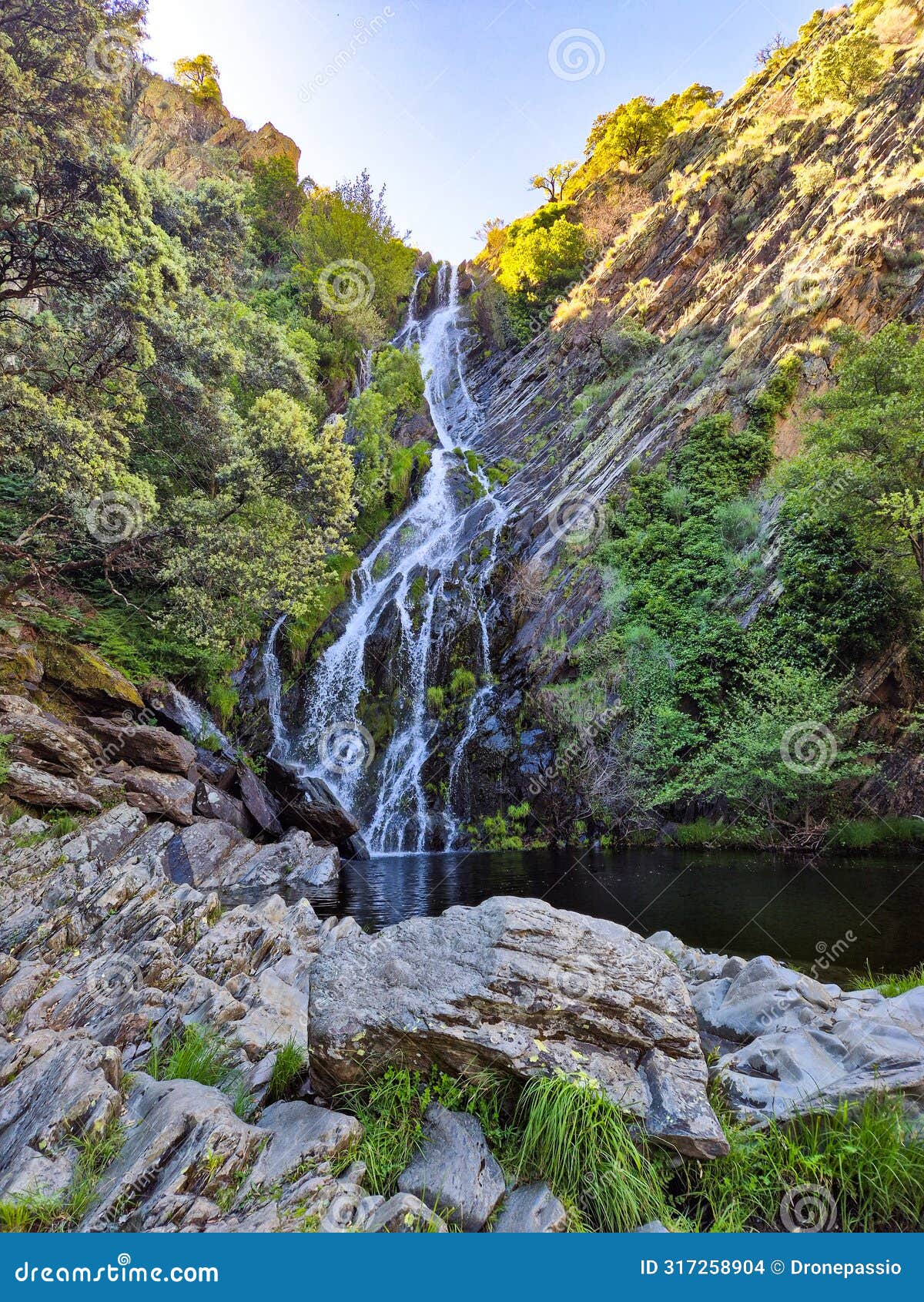 A Crystal Clear Waterfall Cascade Down, Its Gushing Waters Cresting a ...