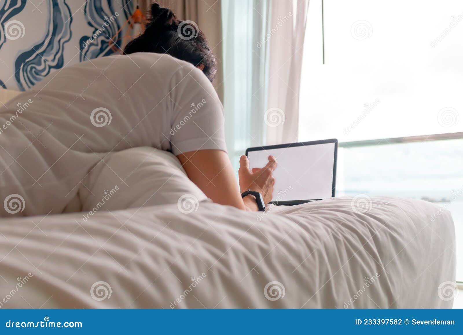 Behind Angle of Man Work on the Bed with Sea View. Concept of Workation ...