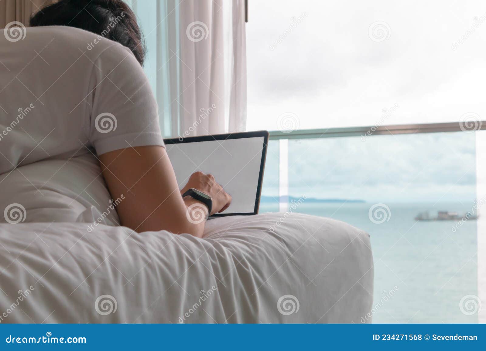 Behind Angle of Man Work on the Bed with Sea View. Concept of Workation ...