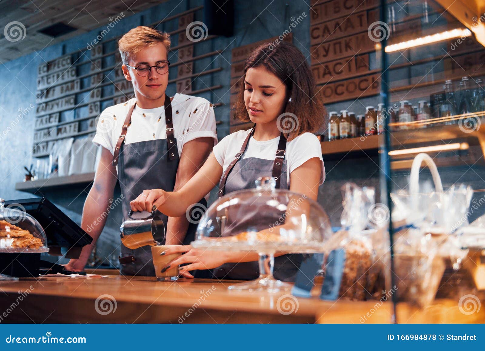 Behind the Bar. Two Young Cafe Workers Indoors Stock Photo - Image of ...