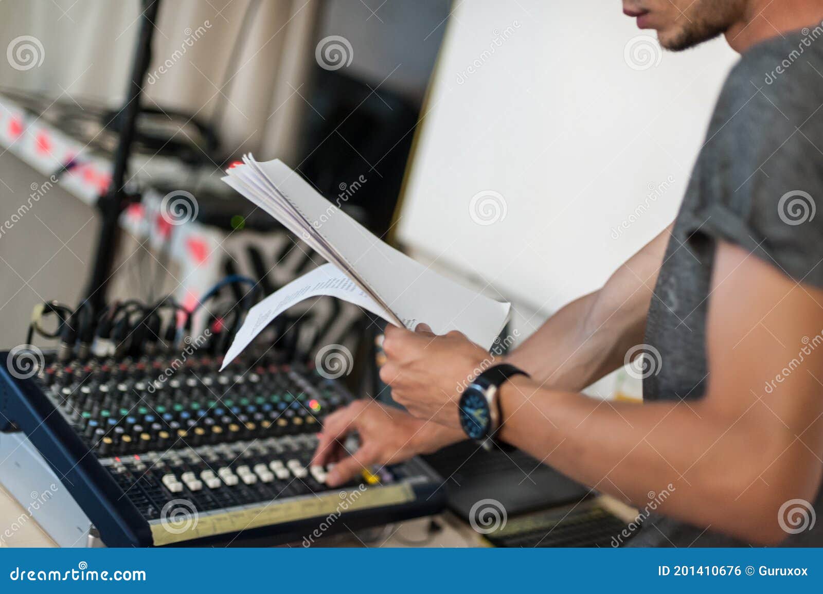 Sound Technician at Theatre Adjusting Sound Elements, Looking at Script ...