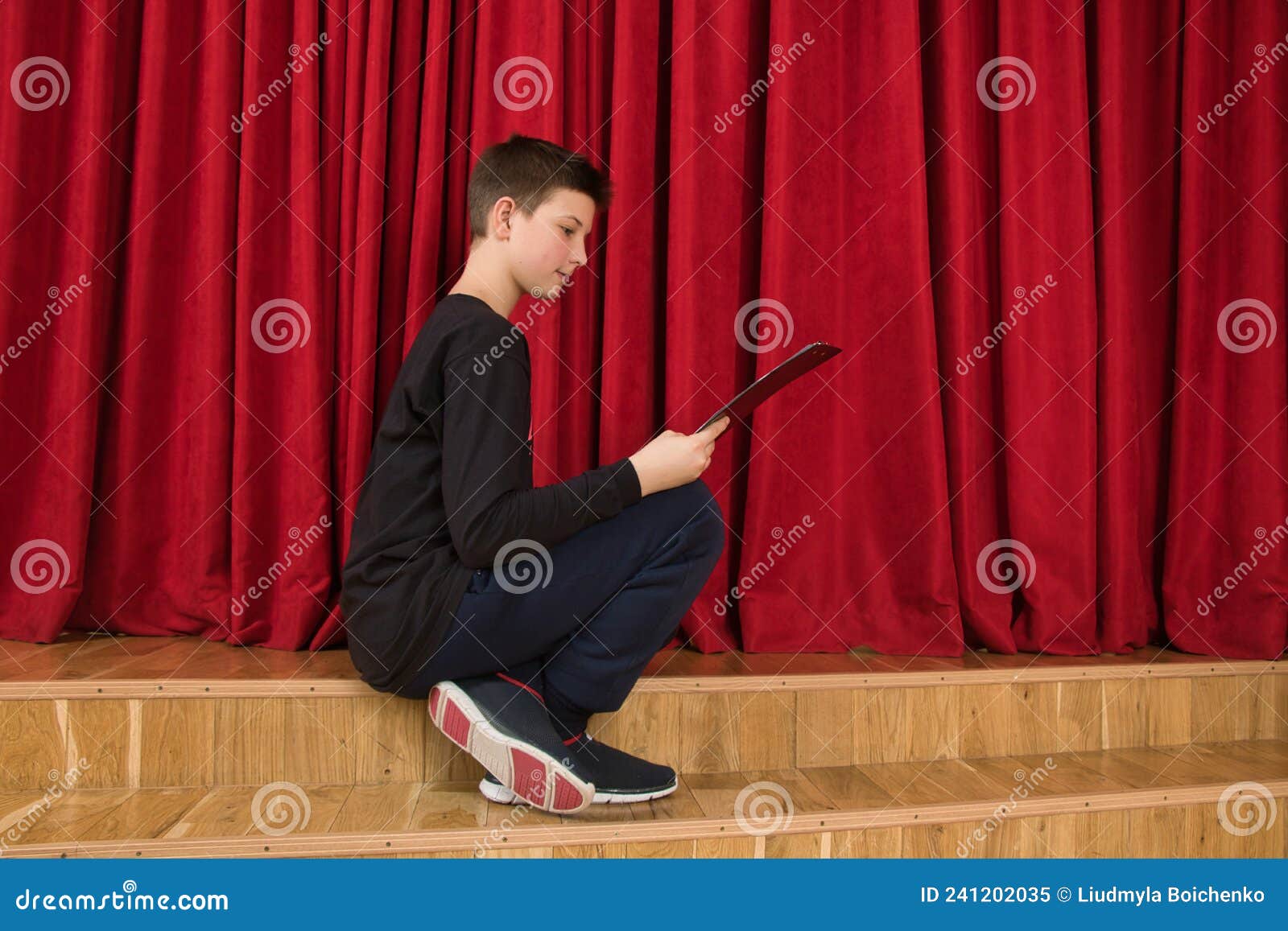 Backstage at the Stage, a Young Actor is Carefully Studying His Script ...