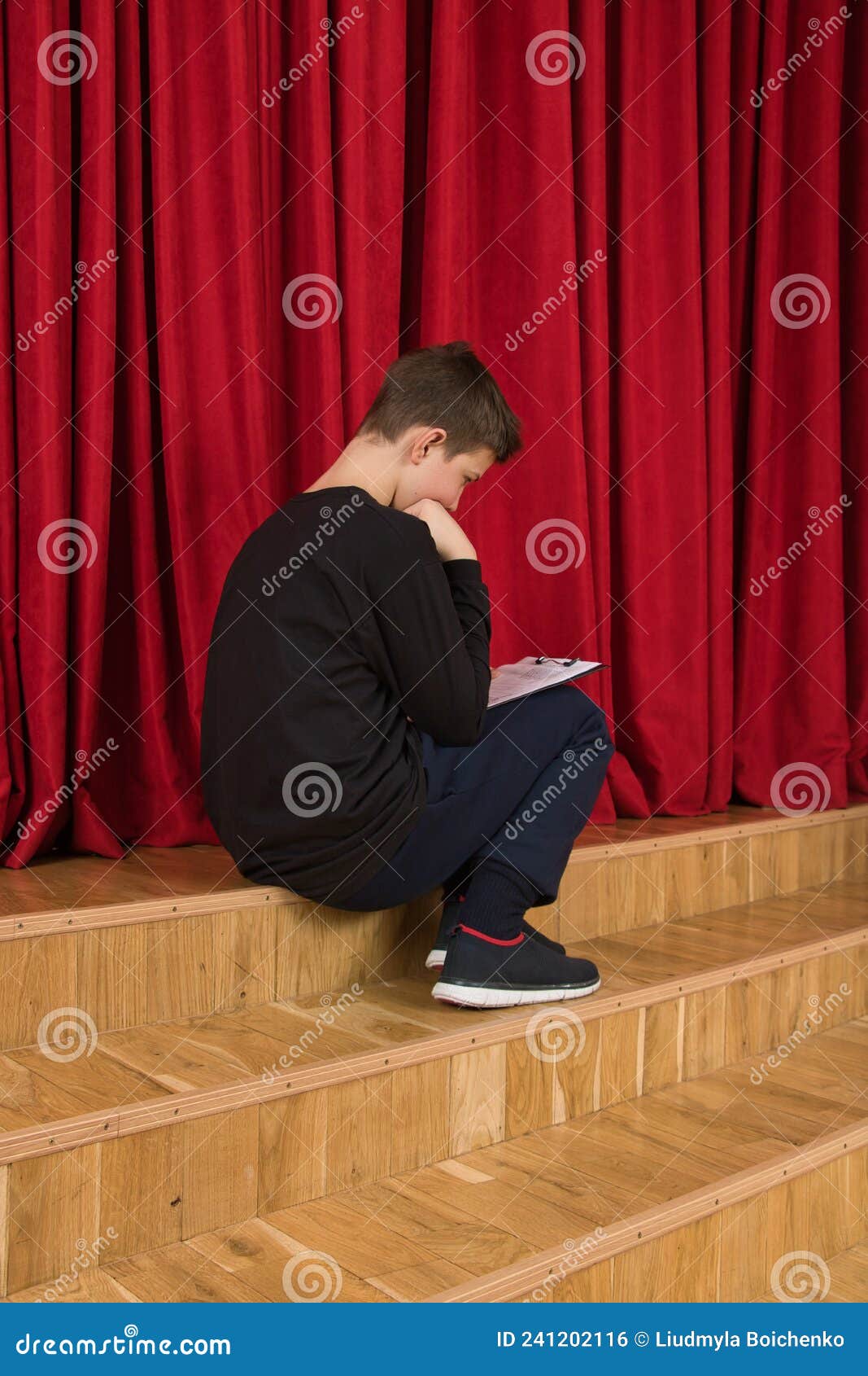 Backstage at the Stage, a Young Actor is Carefully Studying His Script ...