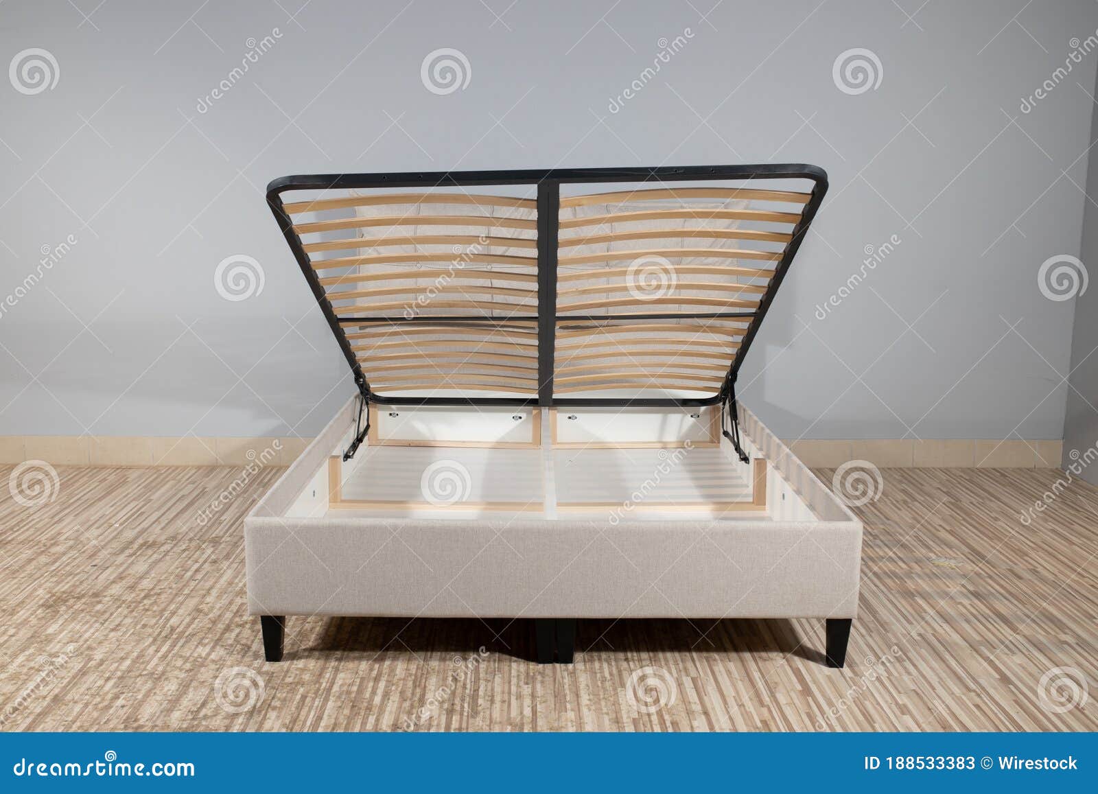Beige Bed with a Storage Space Revealed by Lifting the Wooden Slatted ...