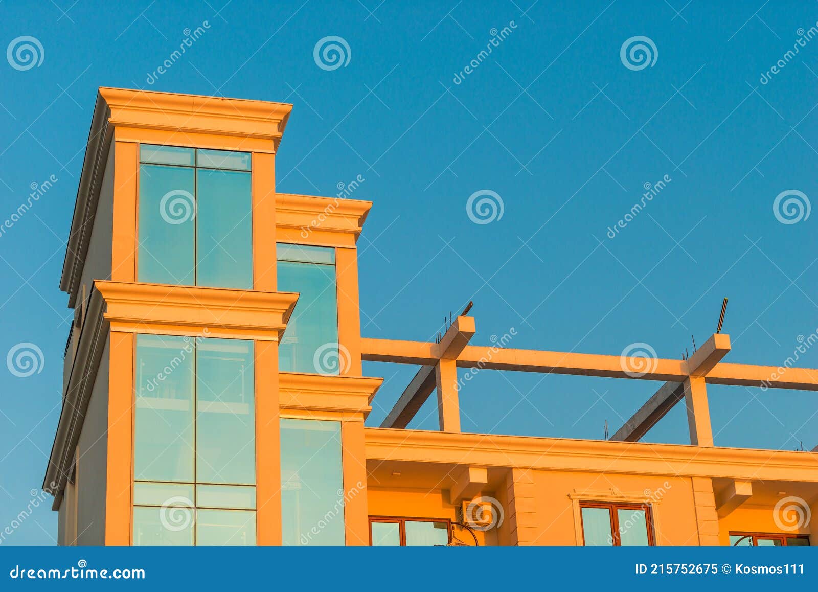 Beige Building with Large Windows Against the Blue Stock Image - Image ...