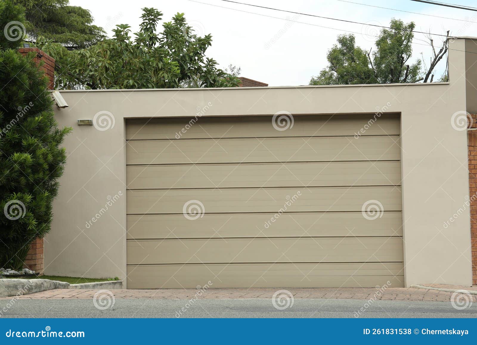 Beige Garage with Closed Sectional Door. Exterior Design Stock Photo ...