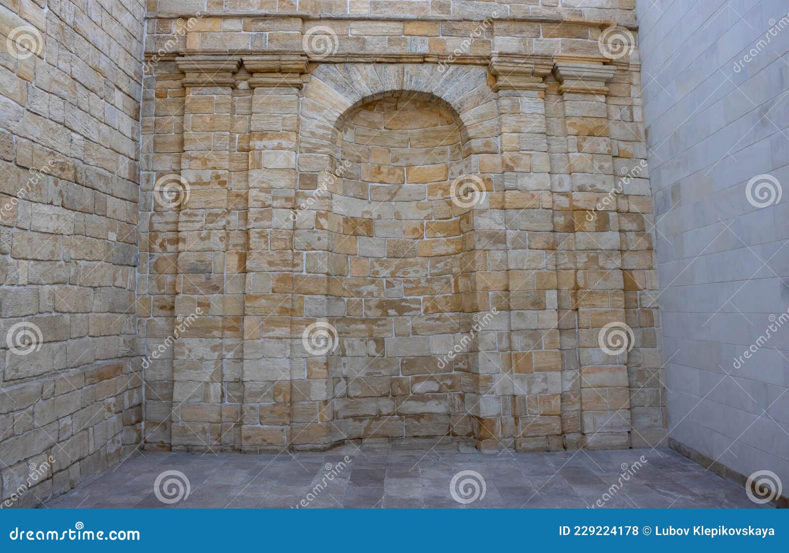 Beige Stone Wall with a Laid Arch Stock Photo - Image of ruins ...