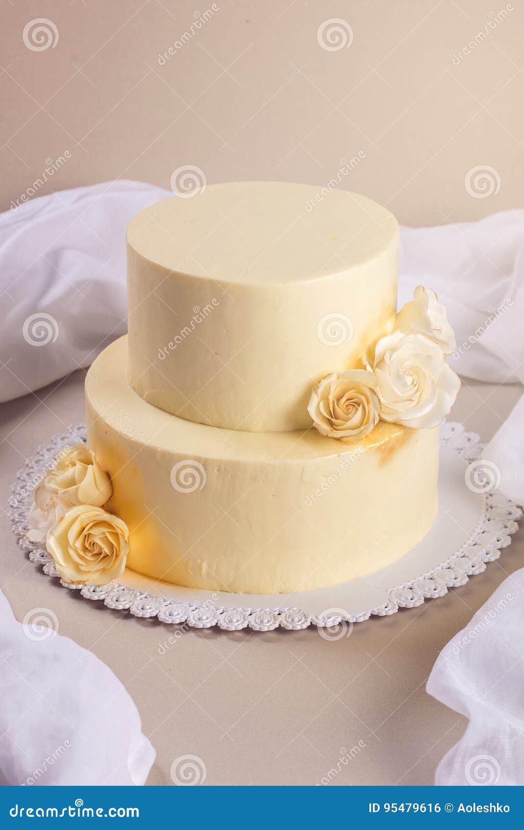 Beige 2 Tiered Wedding Cake Decorated with Mastic Roses Stands on ...