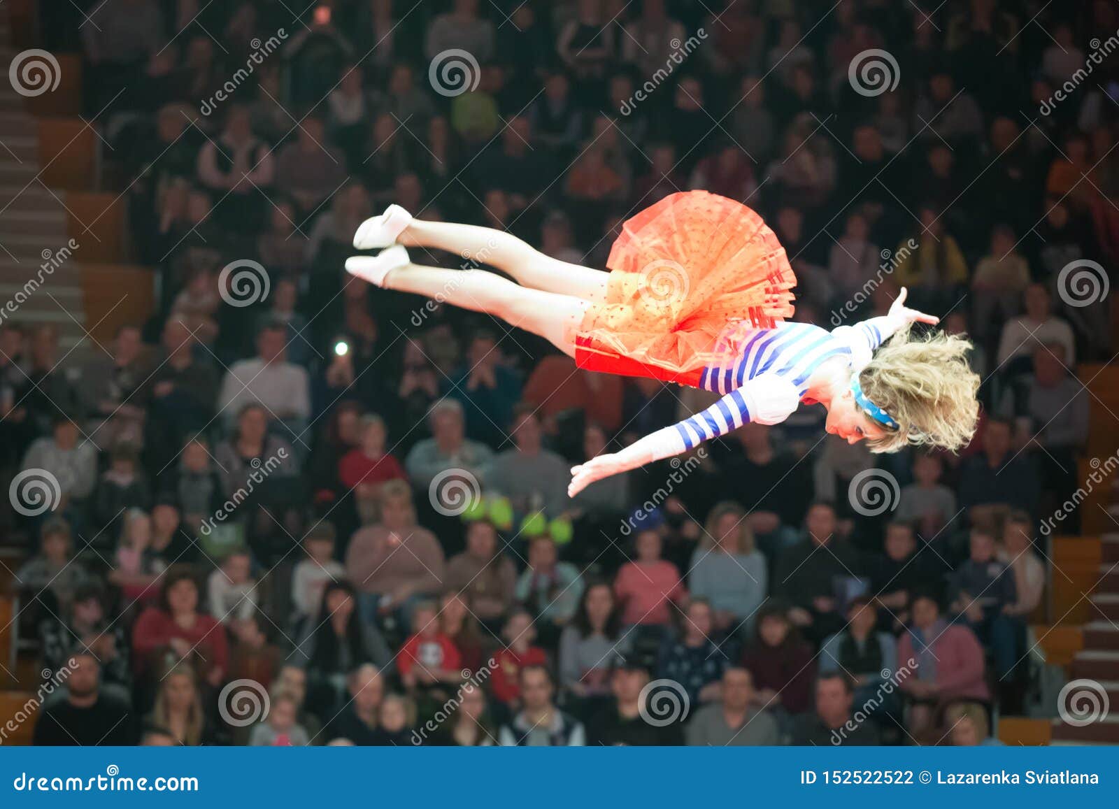 A Clown Acrobat Performs with a Number in Front of an Audience ...