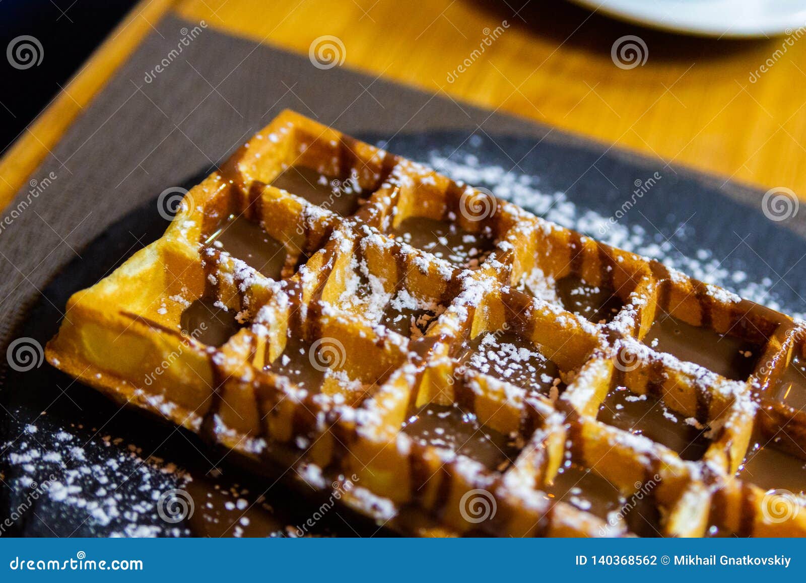 Belgian Waffle with Chocolate Syrup and Powdered Sugar Stock Photo ...