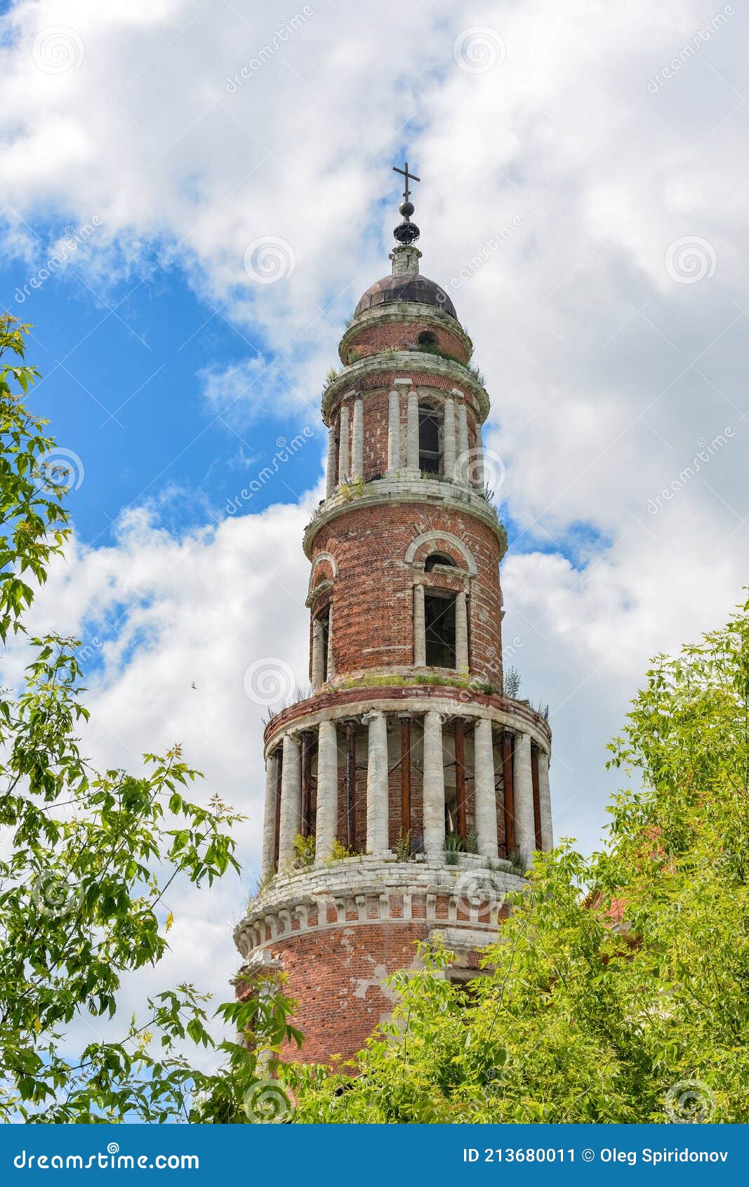 Bell Tower with Columns and a Cross Against the Background of a Cloudy ...
