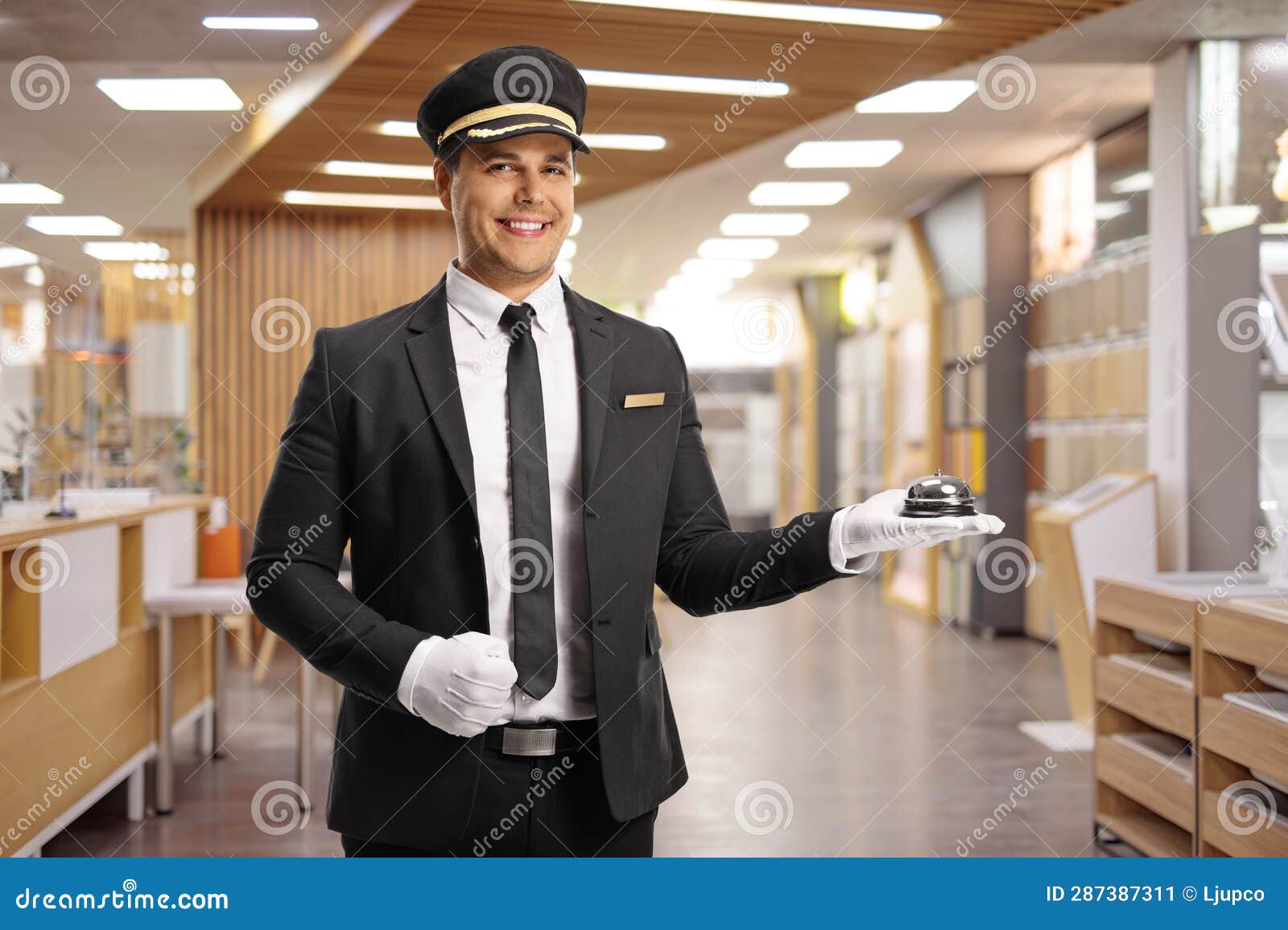 Bellboy Holding a Reception Bell at a Hotel Stock Image - Image of ...