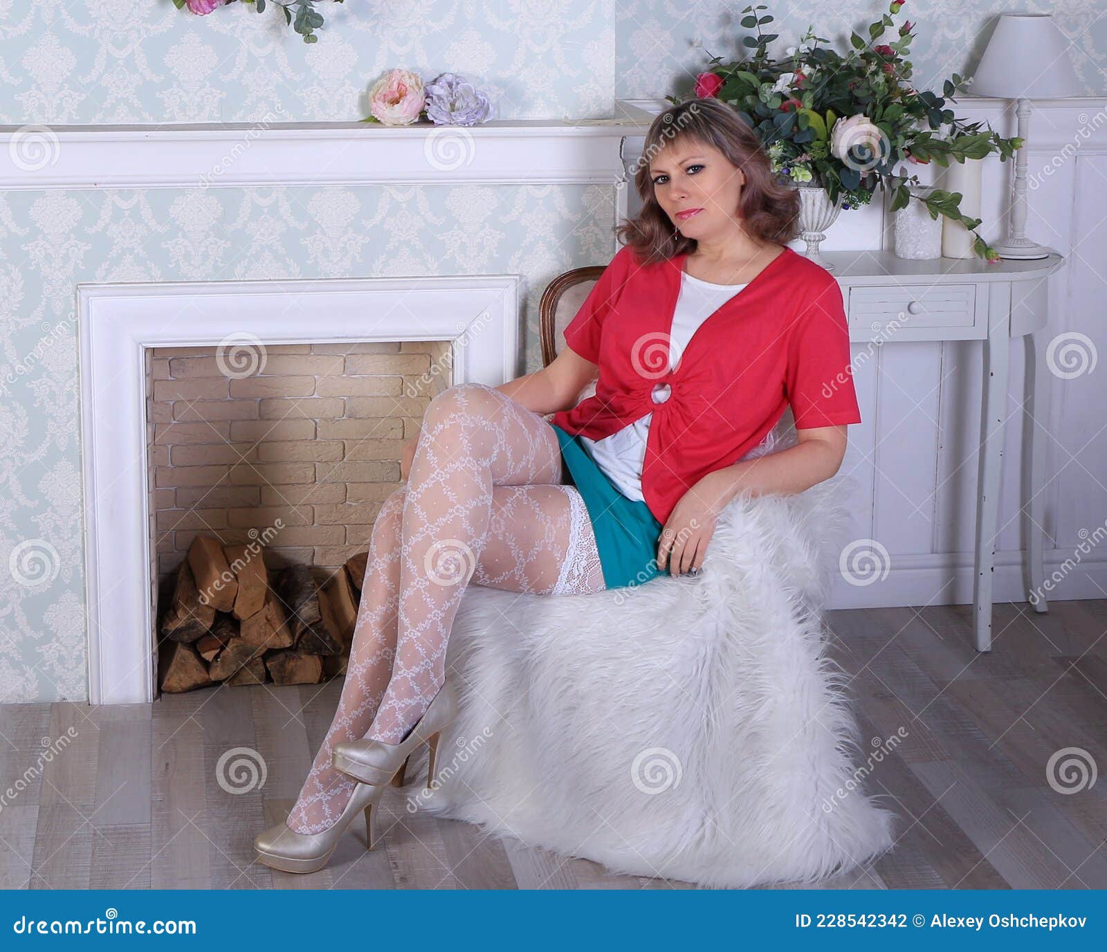 Belle Blonde Aux Pattes En Bas Blancs Et Mini Jupe Verte Pose Sur