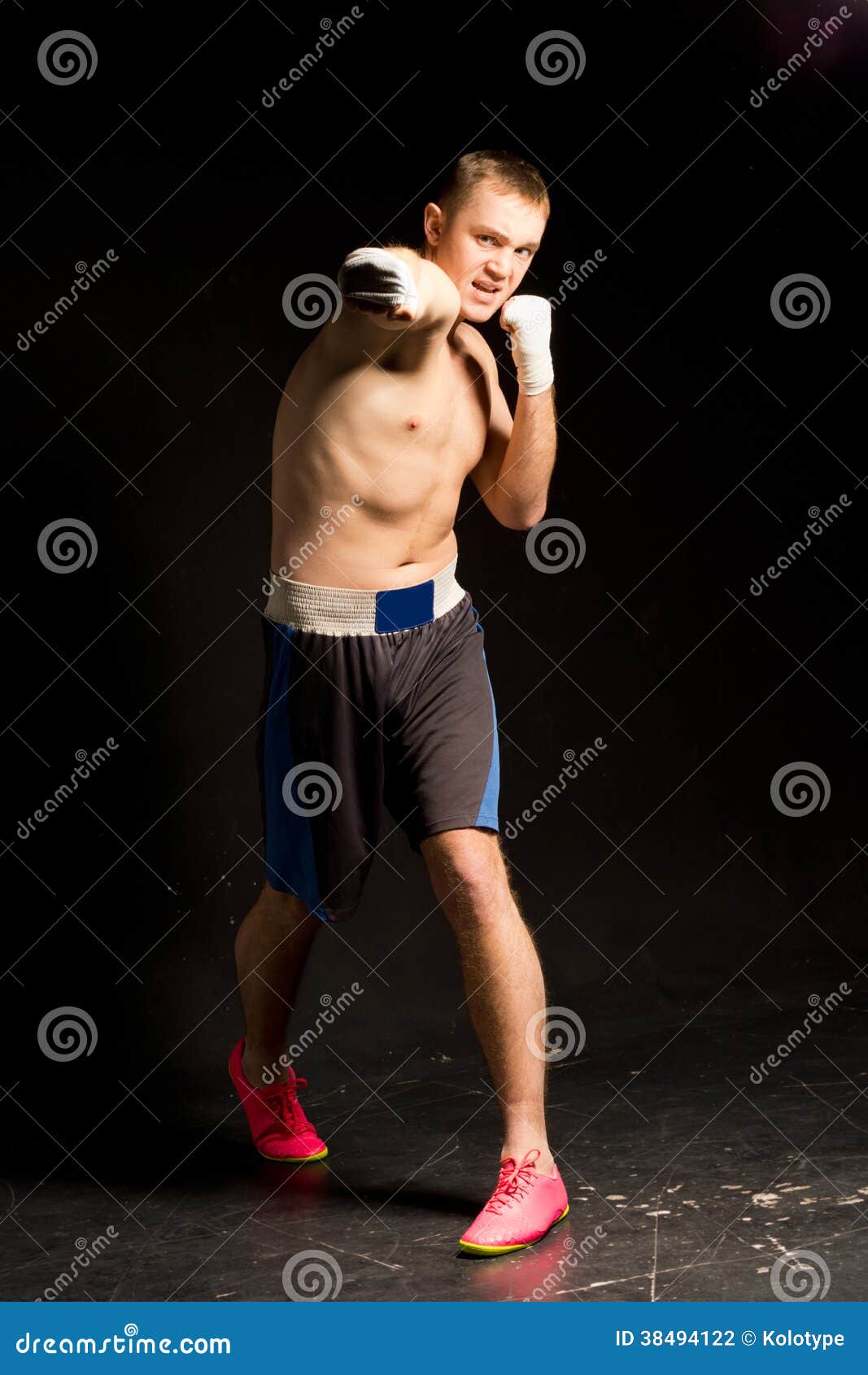 Belligerent Young Boxer Throwing a Punch Stock Photo - Image of length ...