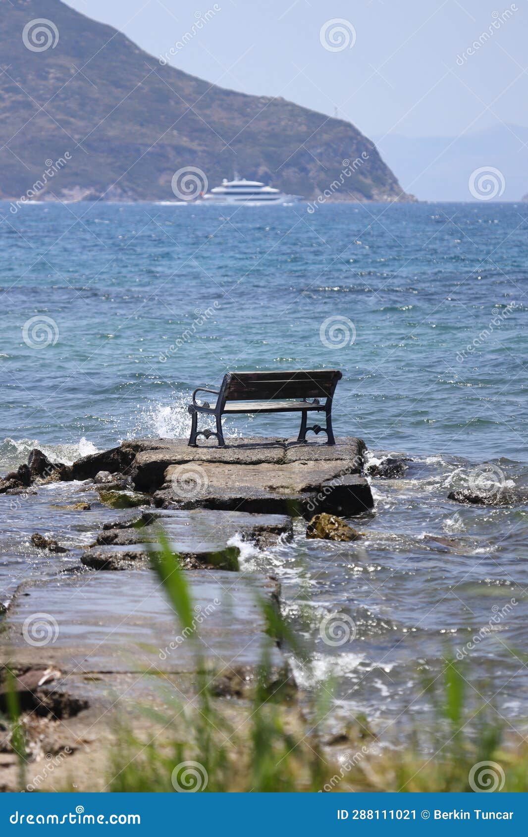Bench on the Beach. a Lonely Bench on the Shore of the Deep Blue Aegean ...
