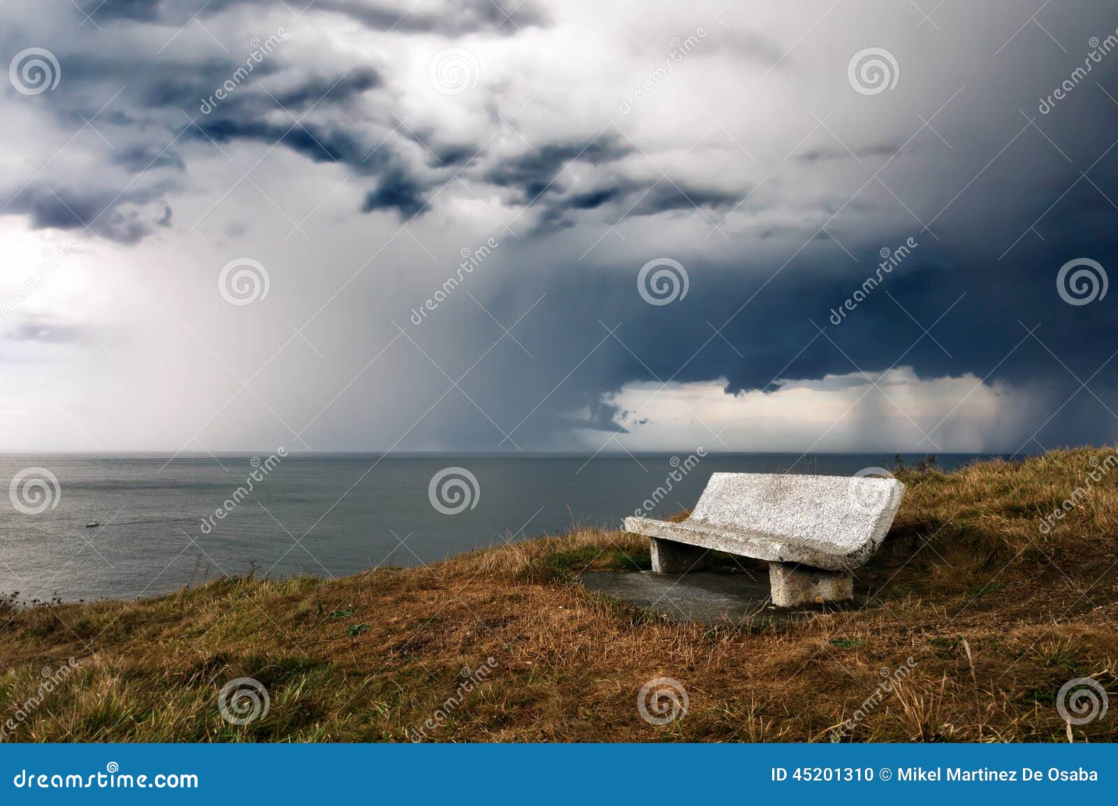 Bench on Cliff with Storm Over Sea Stock Photo - Image of raining ...