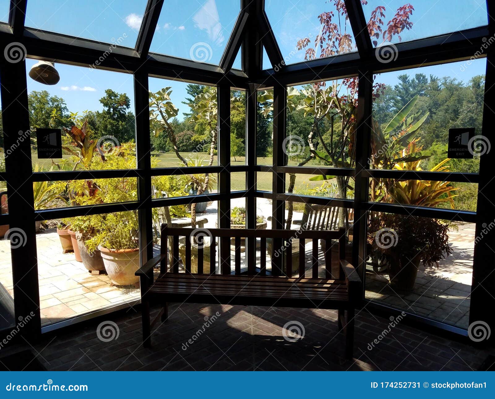 Bench in Greenhouse with Windows and Emergency Exit Signs Stock Image ...
