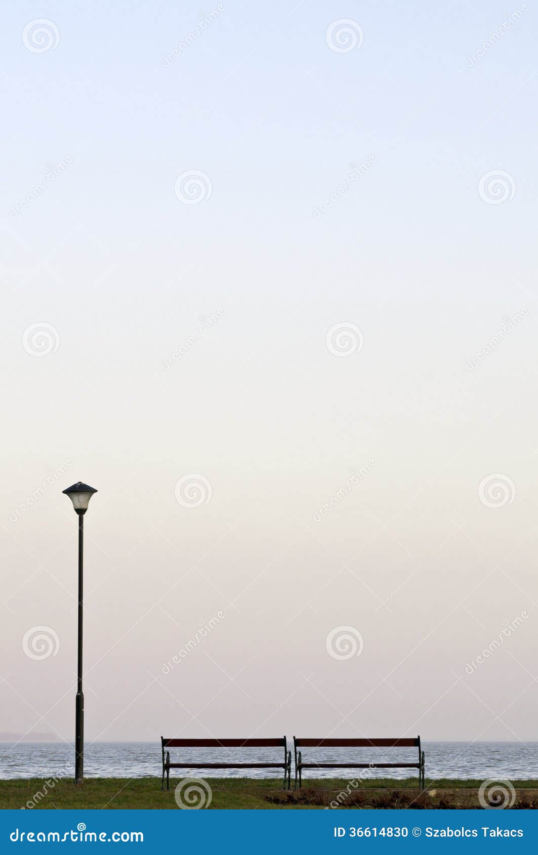 Bench and Lamp Post at Lakeside Vertical Stock Photo - Image of distant ...