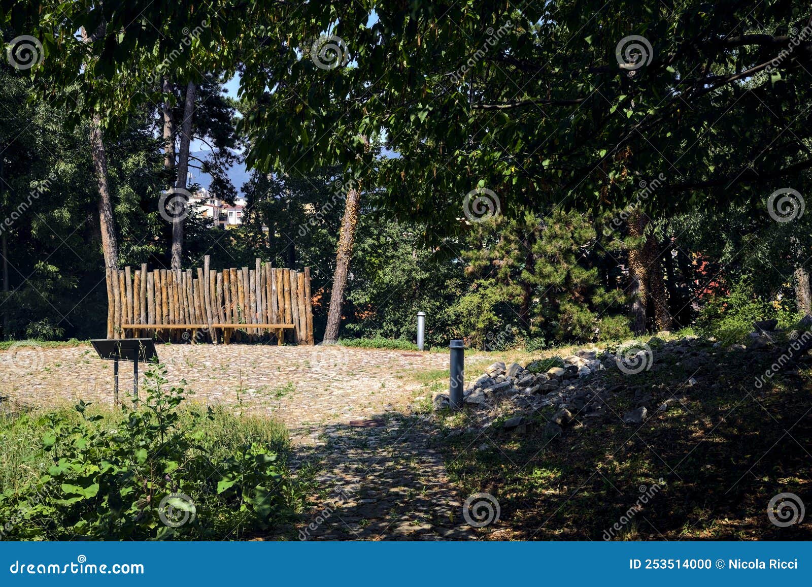 Bench Leaning on a Wooden Fence in a Small Open Space Stock Photo ...