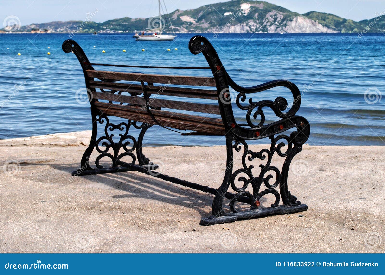 Bench in marina by the sea stock photo. Image of beach - 116833922