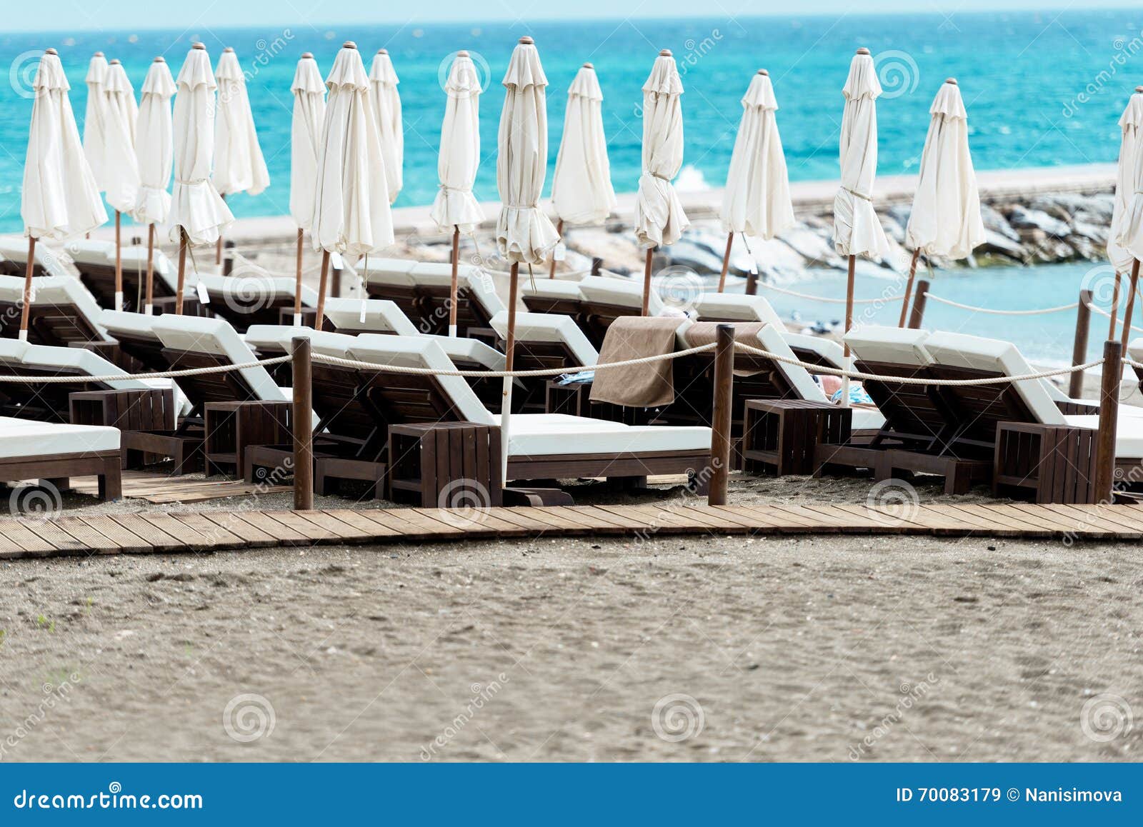 Benches at luxury hotel stock image. Image of umbrella - 70083179