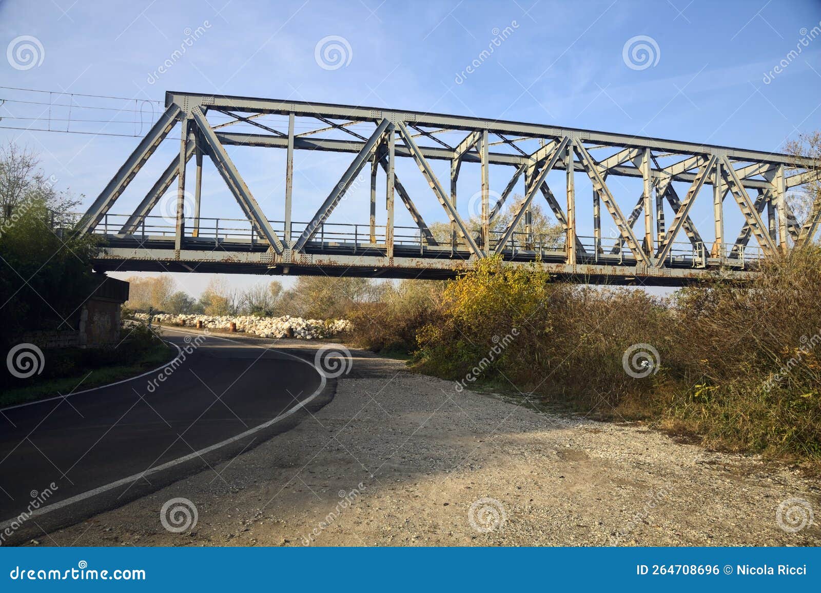 Bend in a Country Road Under a Railroad Bridge Stock Photo - Image of ...