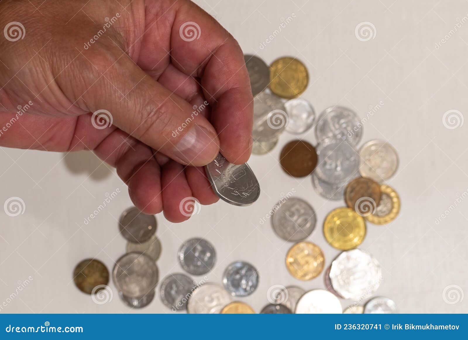 Bent coin in hand of a man stock image. Image of business - 236320741