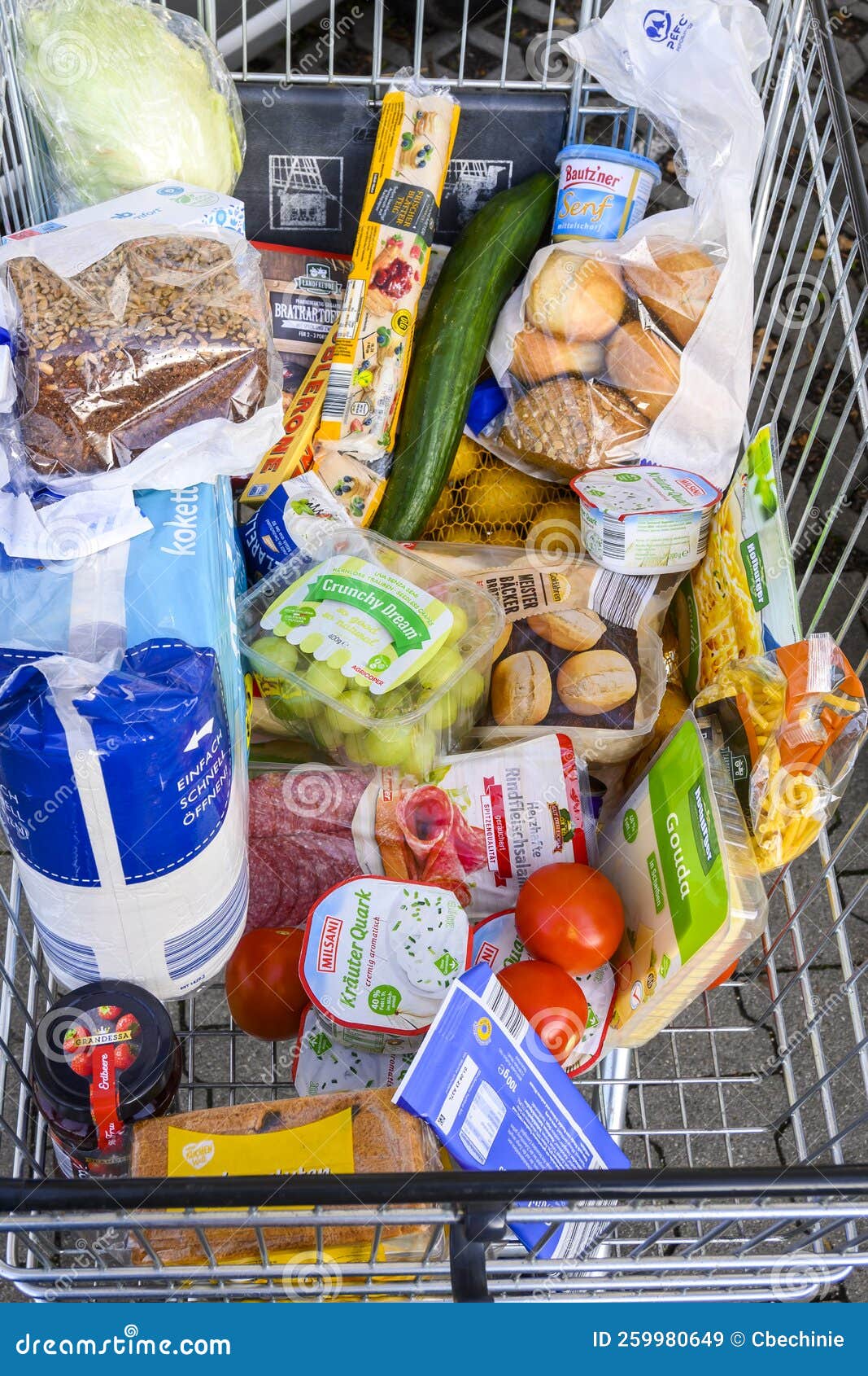 A Full Shopping Cart with Various Products for daily Needs Editorial ...
