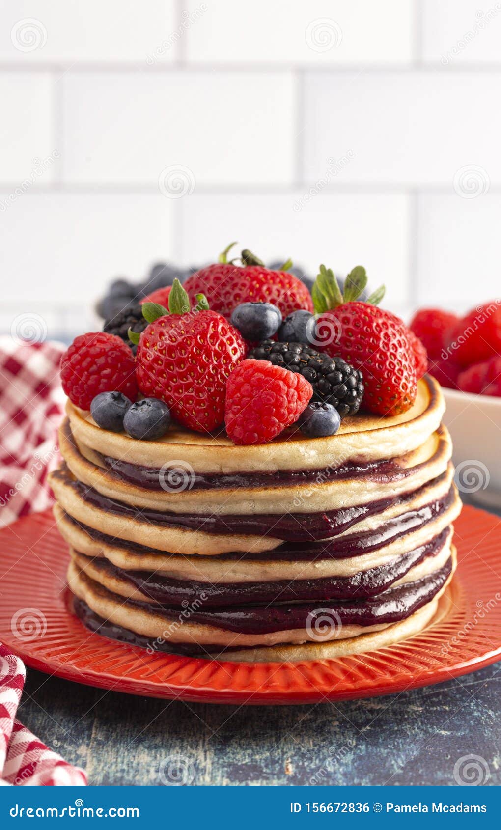 Berry Pancakes with Compote Spread on a Rustic Blue Wood Table Stock ...