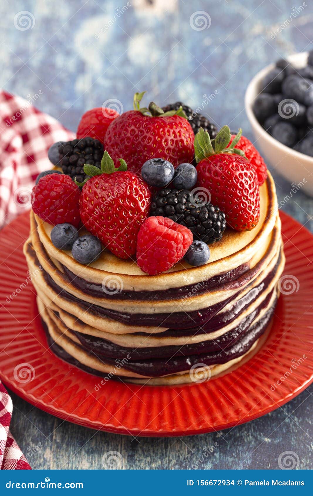 Berry Pancakes with Compote Spread on a Rustic Blue Wood Table Stock ...