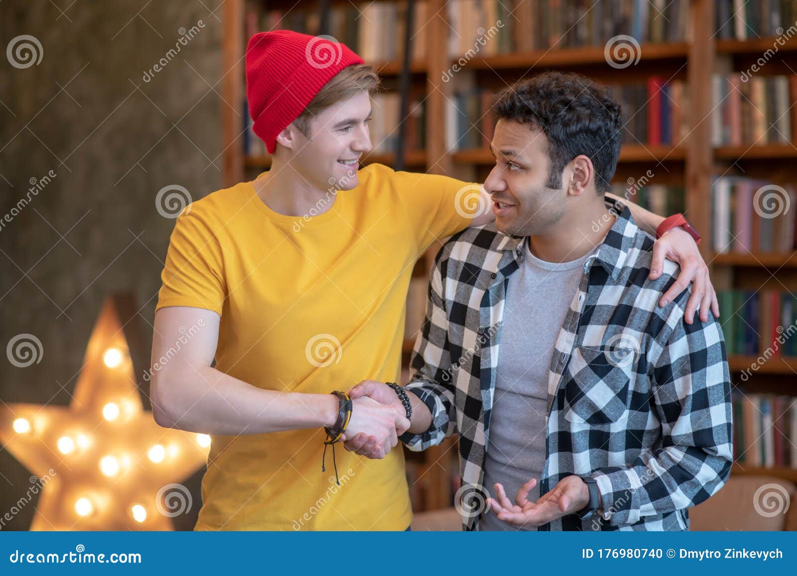 Two Young Handsome Men Standing in the Room and Talking Stock Photo ...