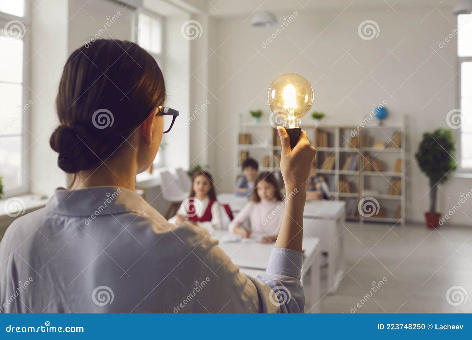 Best Teacher with Idea Light Bulb Inspires Elementary Children at ...