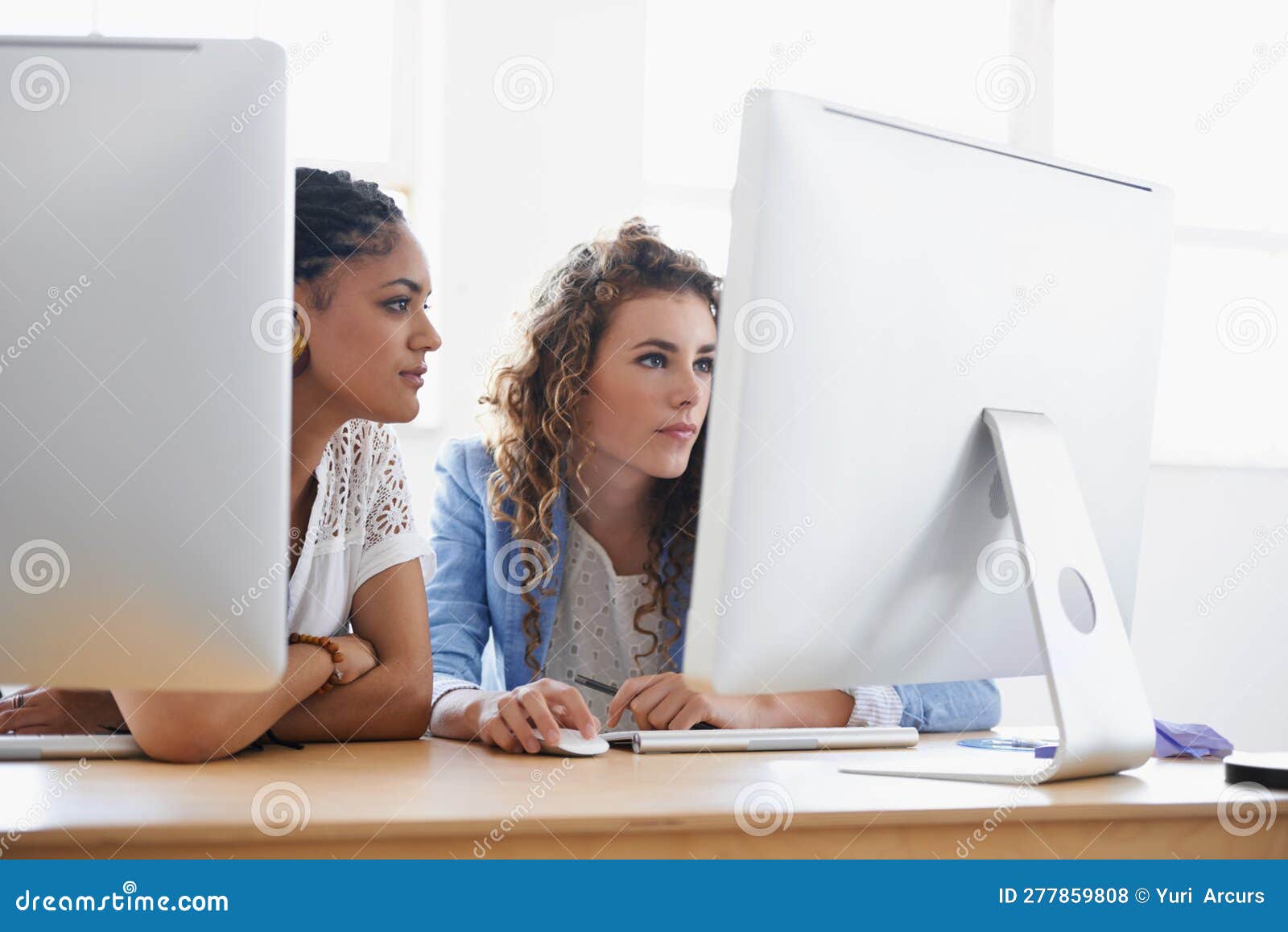 Beta Testing Their New Program. a Female Colleagues Going Over Their ...
