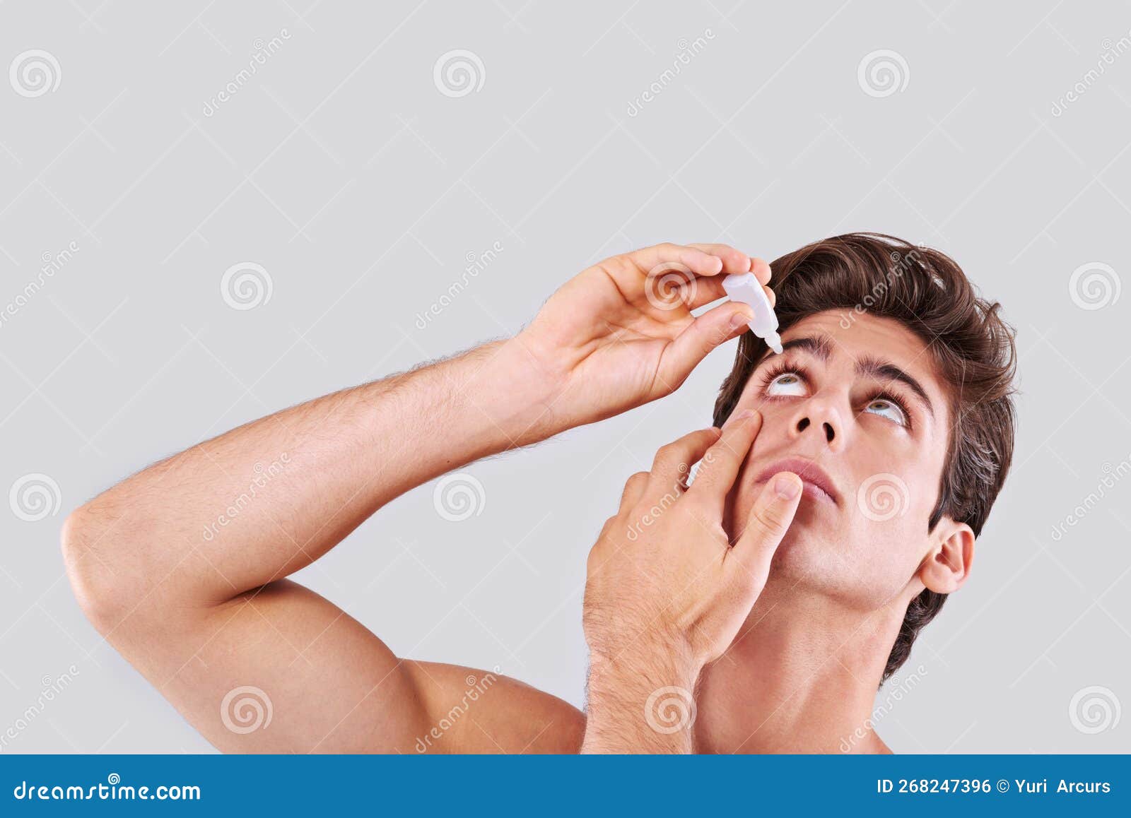 For Better Vision. Studio Shot of a Handsome Bare Chested Young Man ...